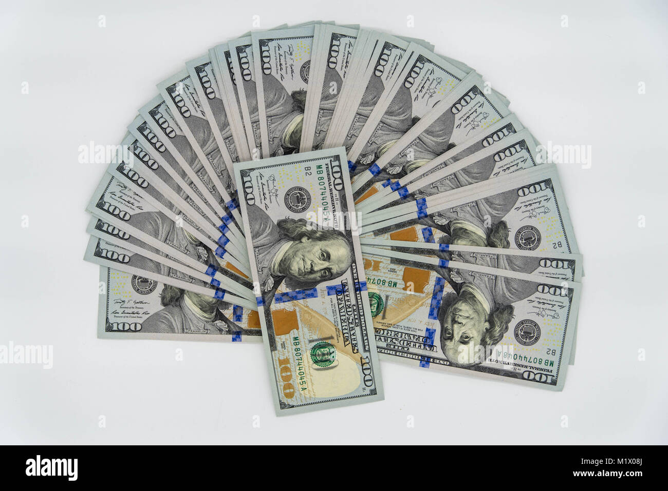 a stack of us 100 dollars cash with white background Stock Photo - Alamy