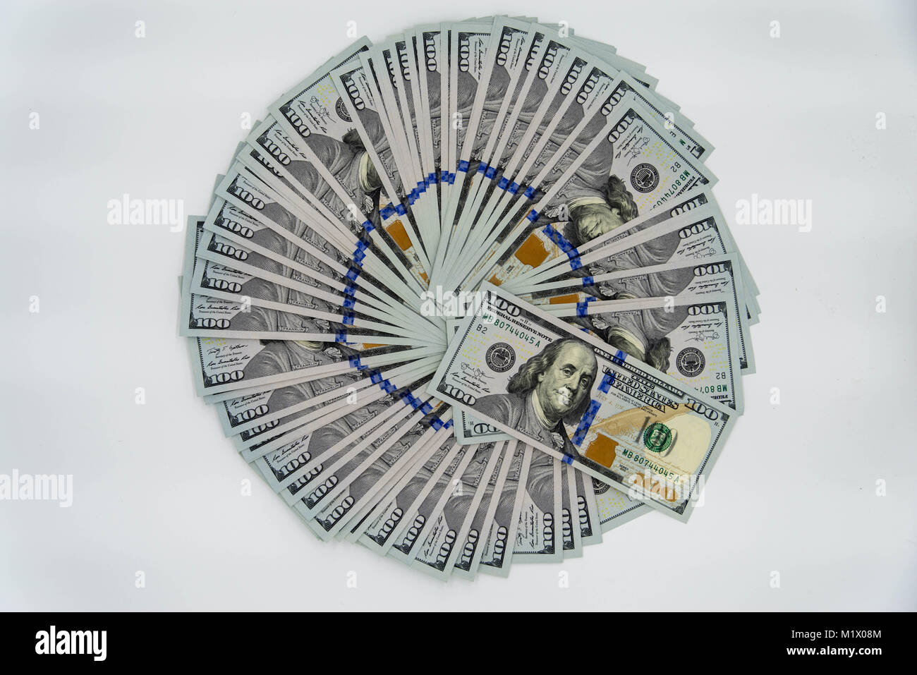 a stack of us 100 dollars cash with white background Stock Photo - Alamy