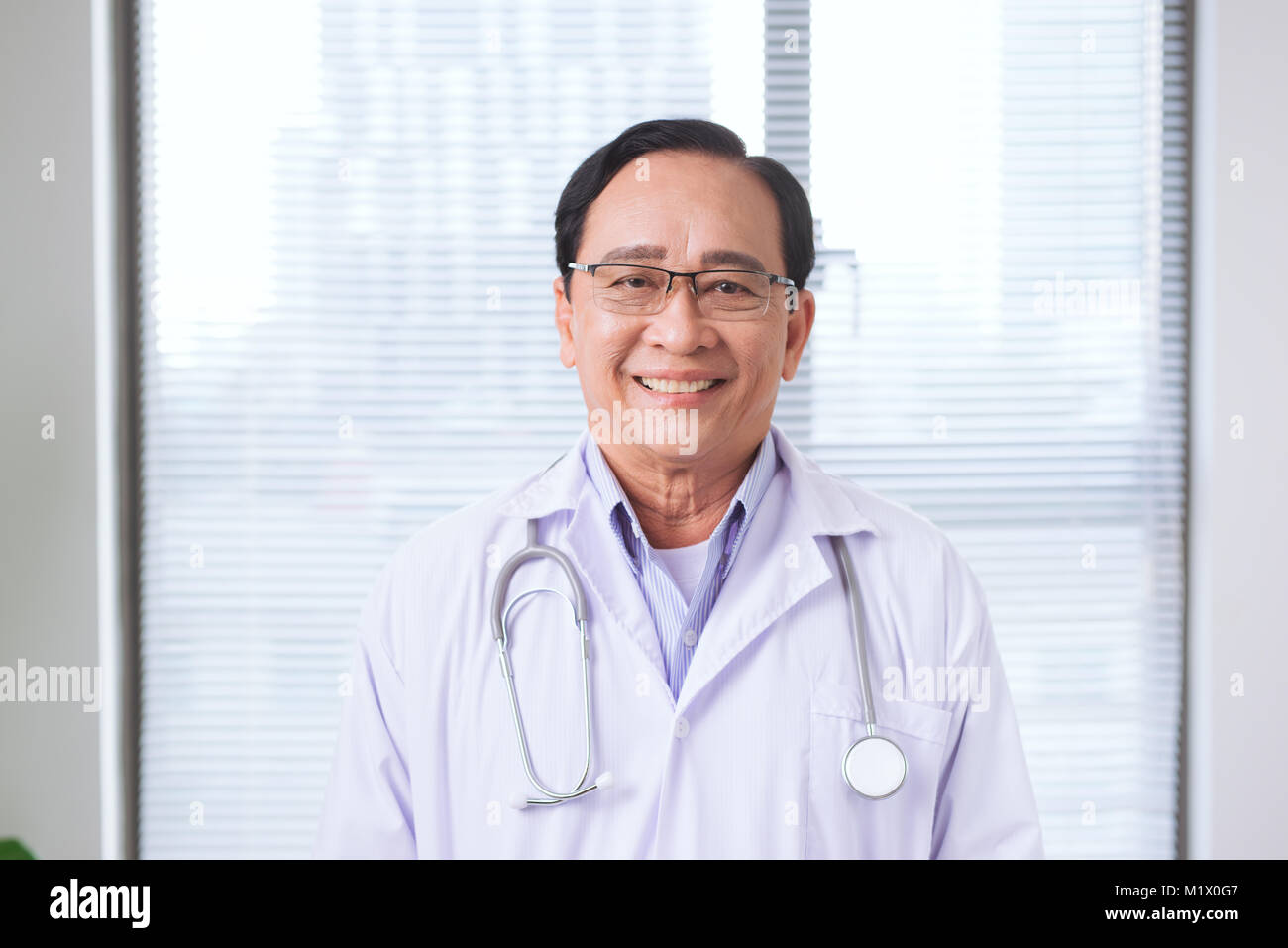 Doctor in his office hi-res stock photography and images - Alamy