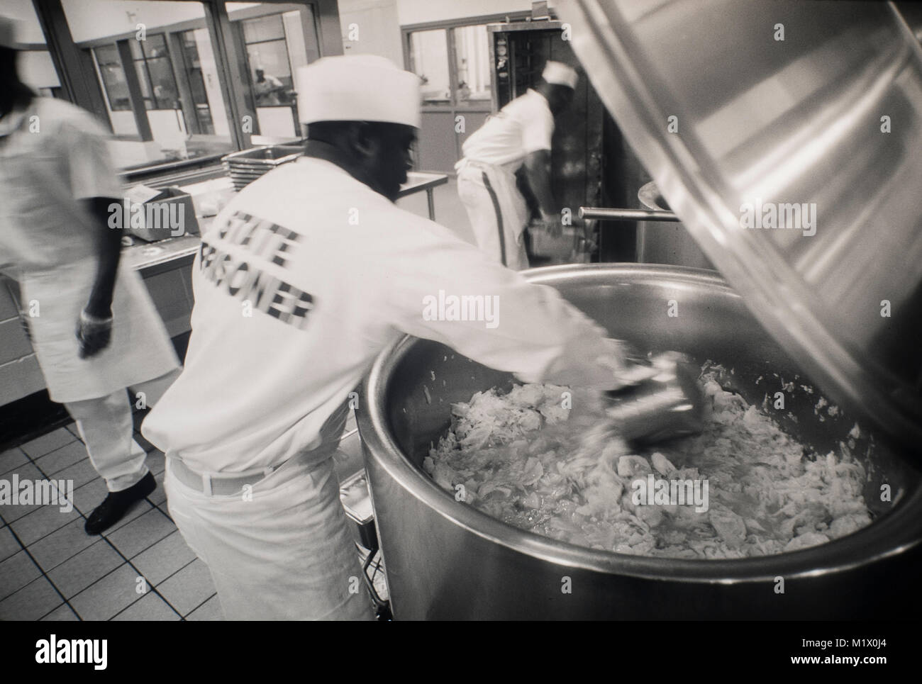 Convicts work in a prison kitchen inside a state prison in Georgia, USA ...