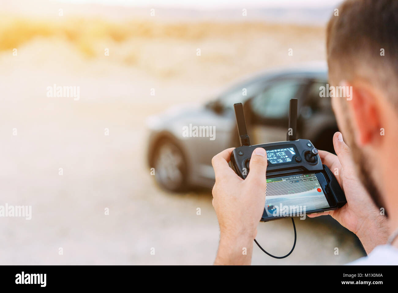 Guy controls drone with remote control Stock Photo - Alamy
