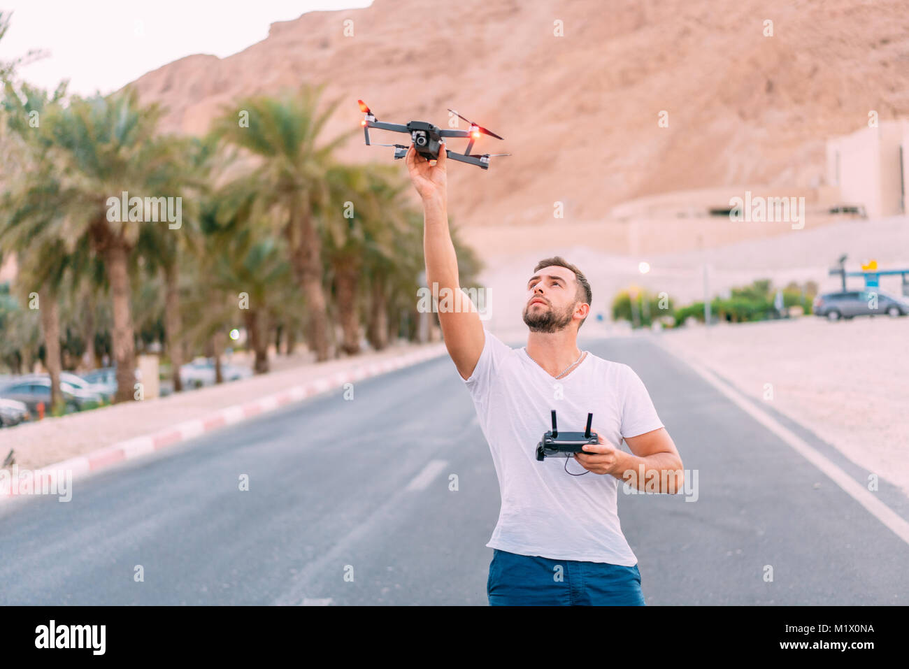 Young man holding drone before flight at nature Stock Photo - Alamy