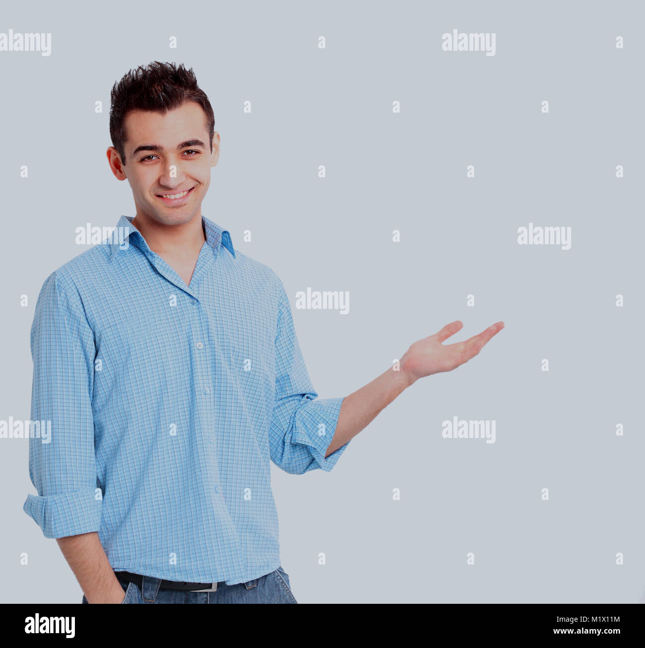 Happy young business man presenting over a white background Stock Photo ...