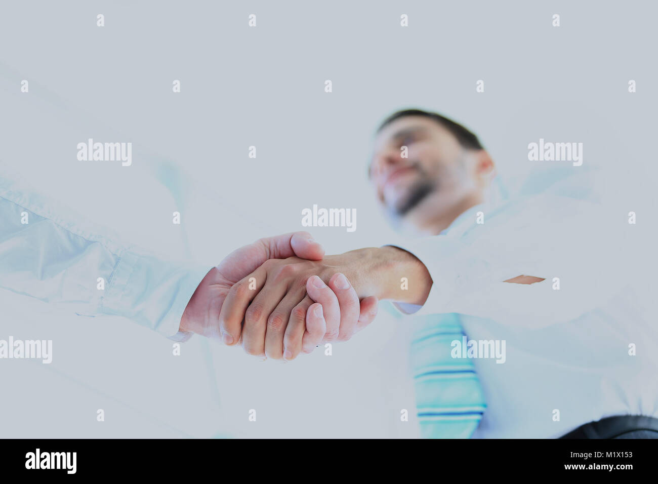 Low angle-shot of shake hands Stock Photo - Alamy