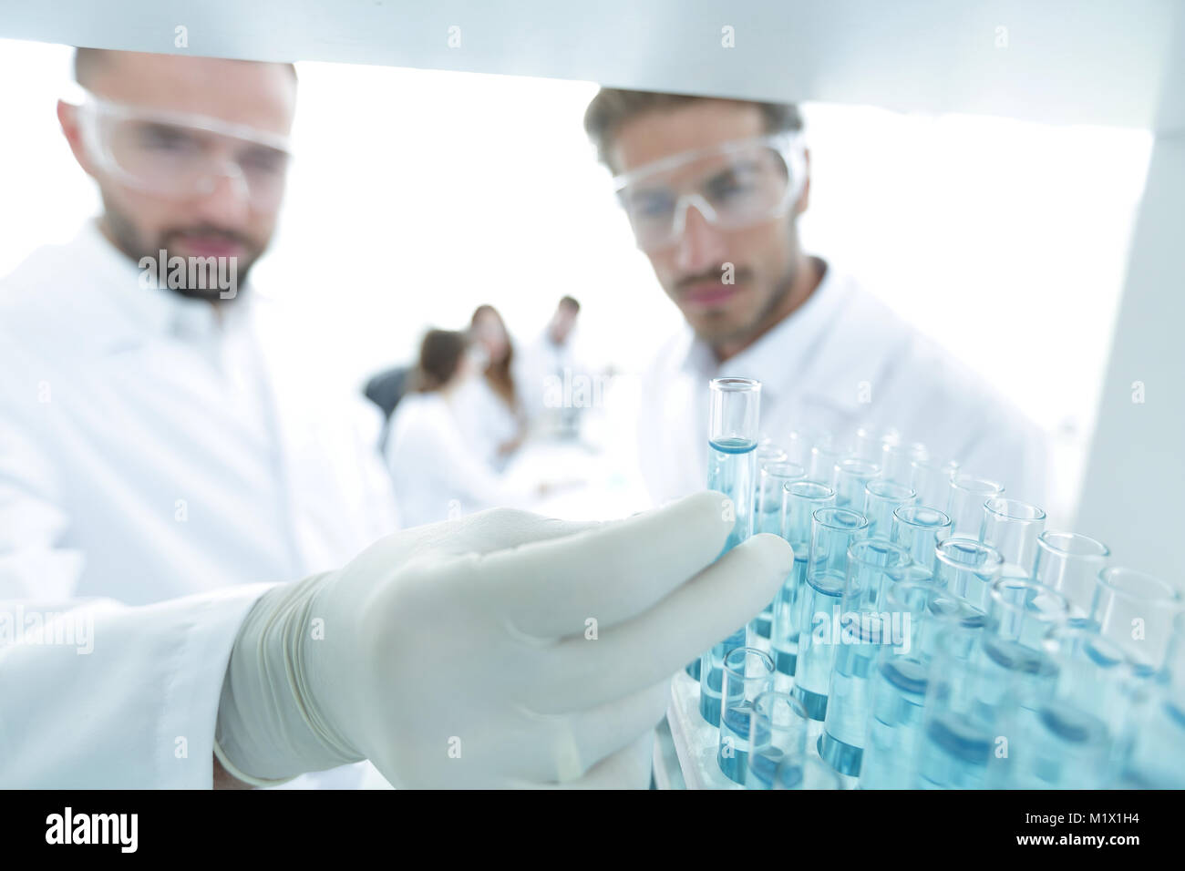 scientist and assistant studying the solution in the tube Stock Photo ...