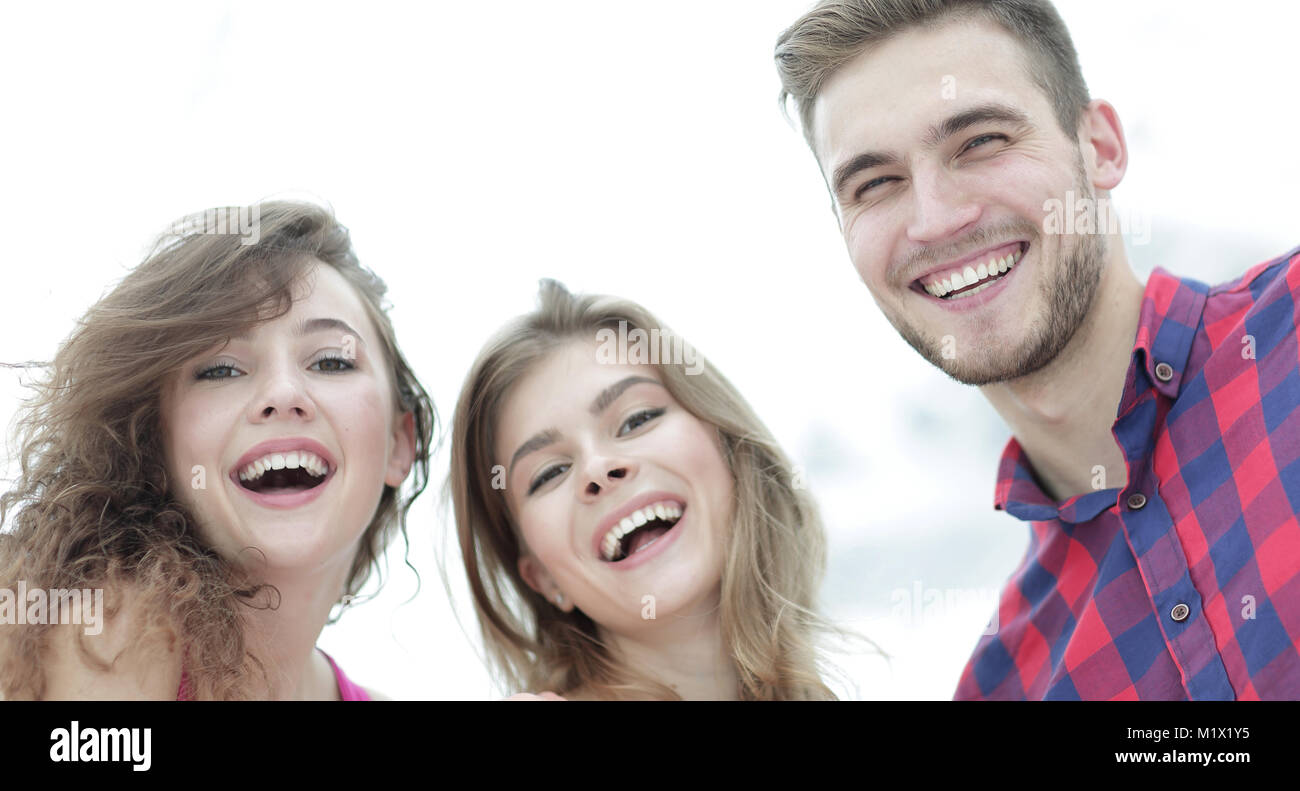 closeup of three young people smiling on white background Stock Photo ...