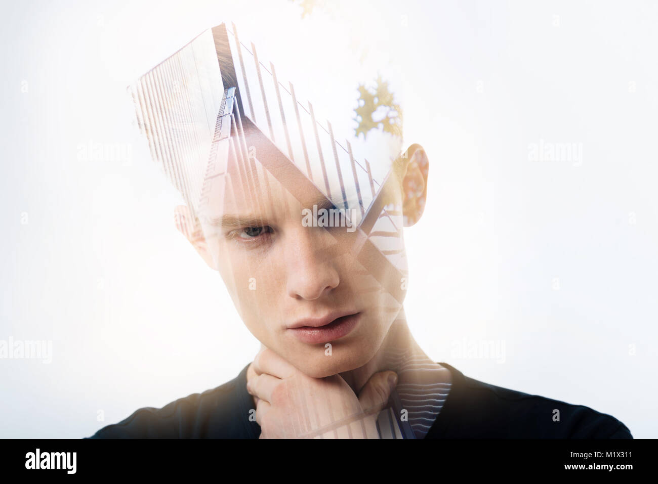 Serious thoughtful boy looking straight and touching to his neck Stock ...