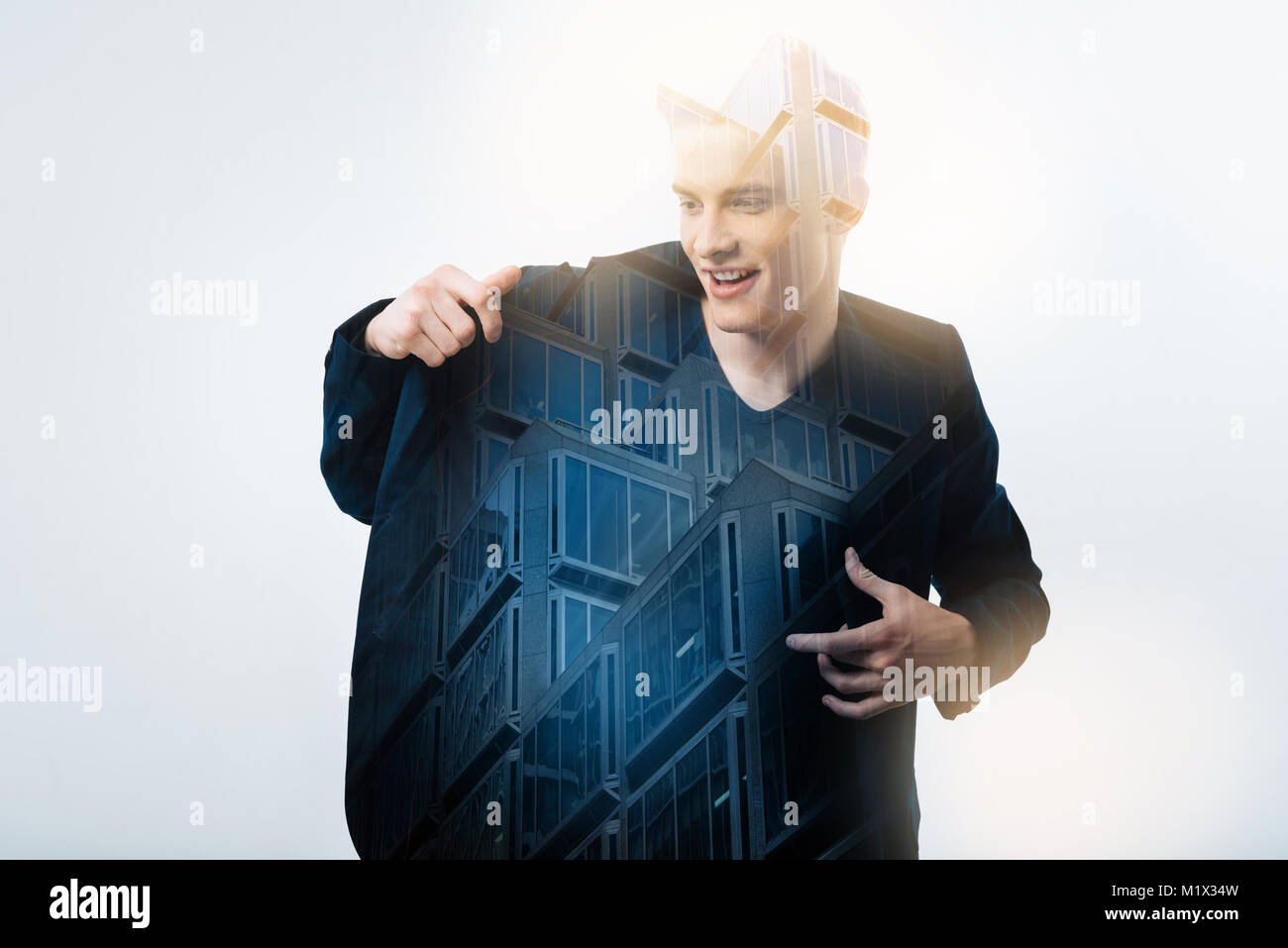 Satisfied handsome man standing and rejoicing Stock Photo - Alamy