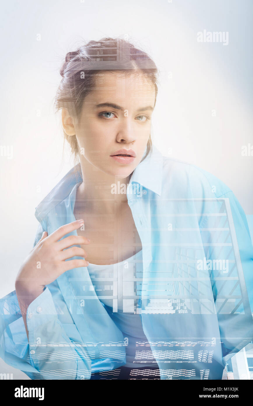 Young beautiful girl holding hand near her neck looking straight Stock ...