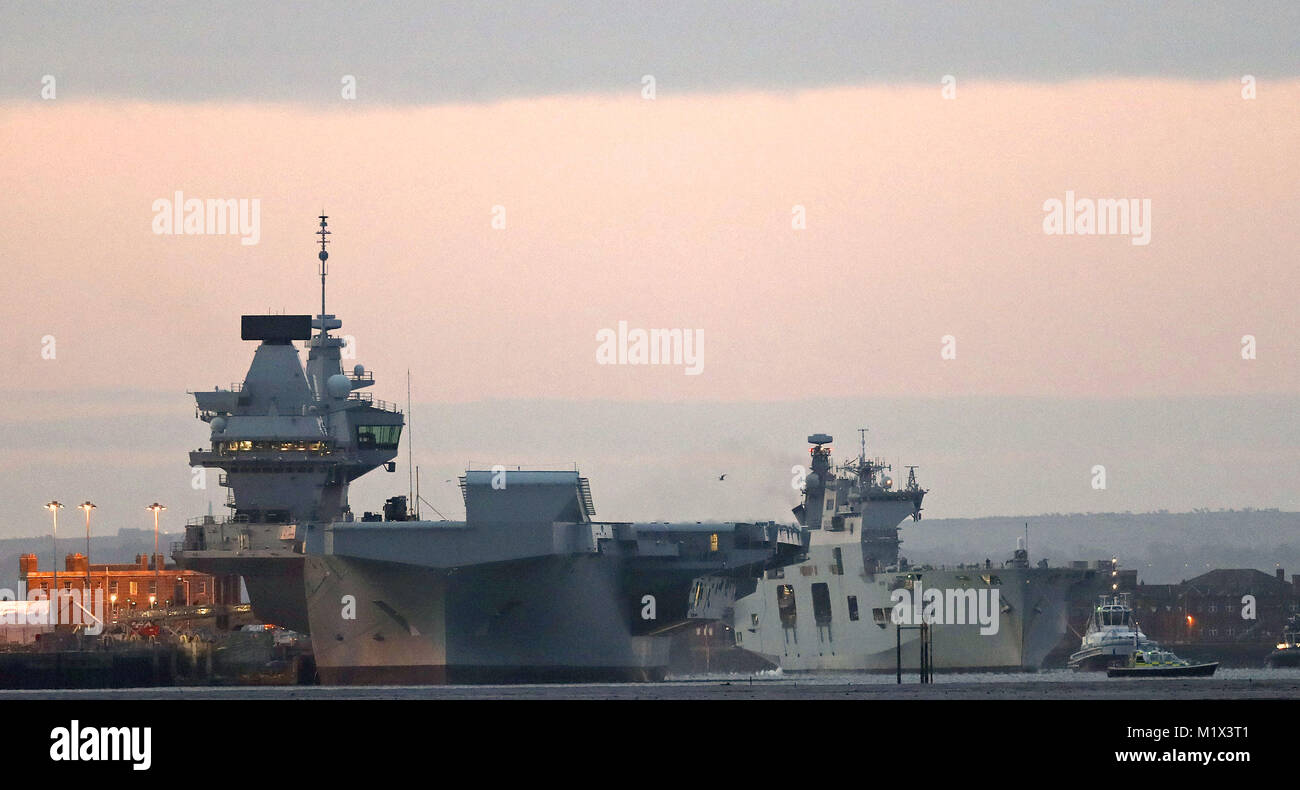 HMS Ocean (right) sails into Portsmouth and docks next to the new ...