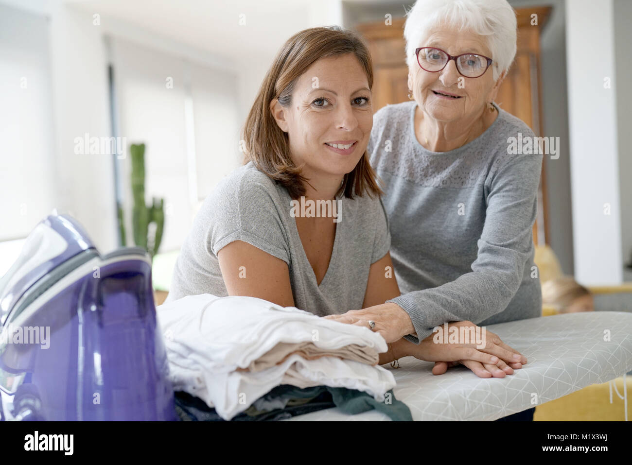 Portrait of elderly woman with housekeeper Stock Photo - Alamy