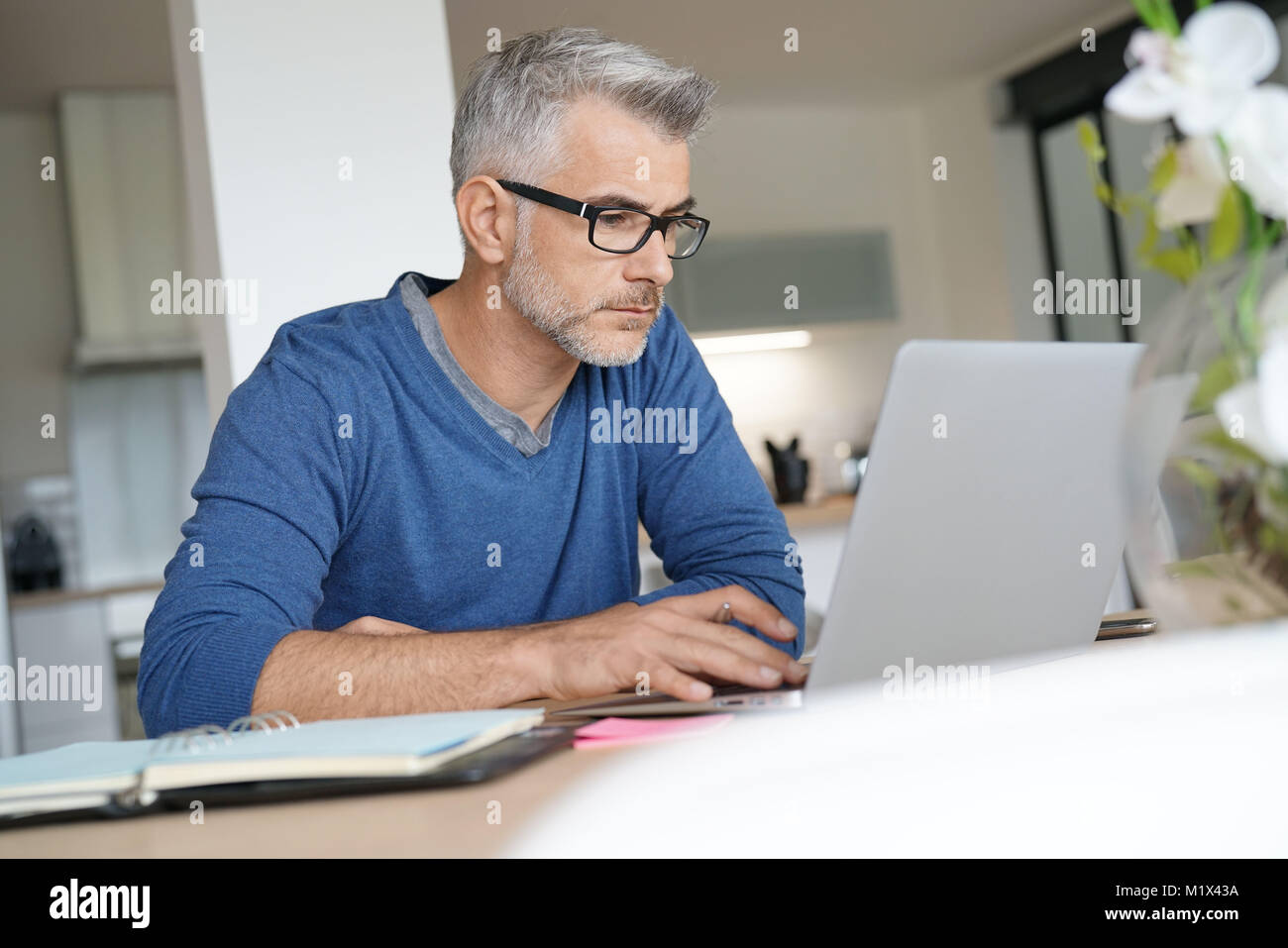 Middle-aged man working from home-office on laptop Stock Photo - Alamy