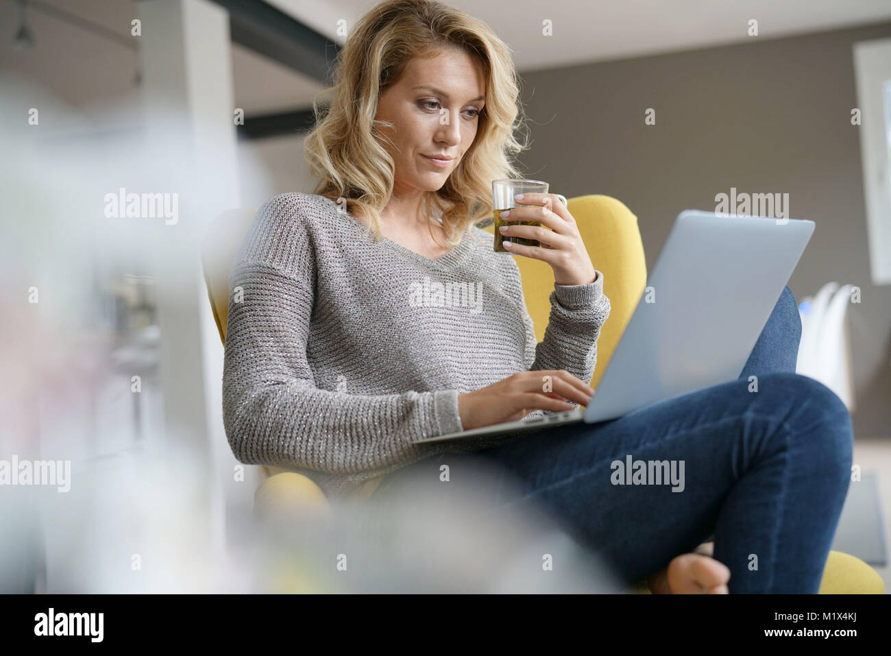 Woman at home connected on laptop computer Stock Photo - Alamy
