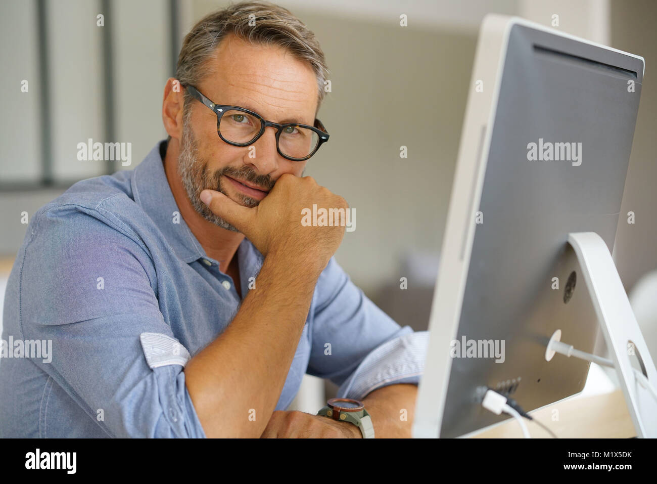 Businessman working on desktop computer Stock Photo - Alamy