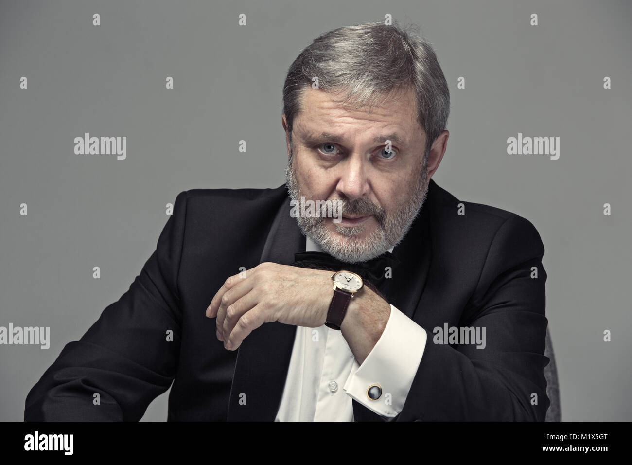 Senior Businessman sitting in chair Stock Photo - Alamy