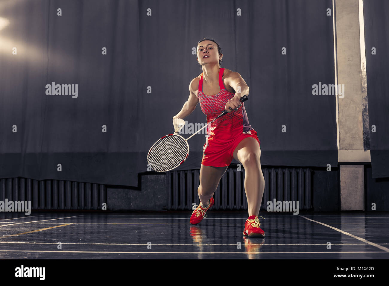 Young woman playing badminton at gym Stock Photo - Alamy