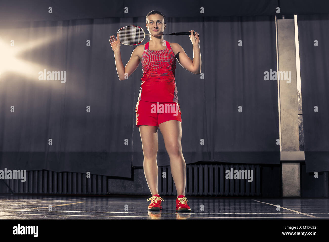 Young woman playing badminton at gym Stock Photo - Alamy