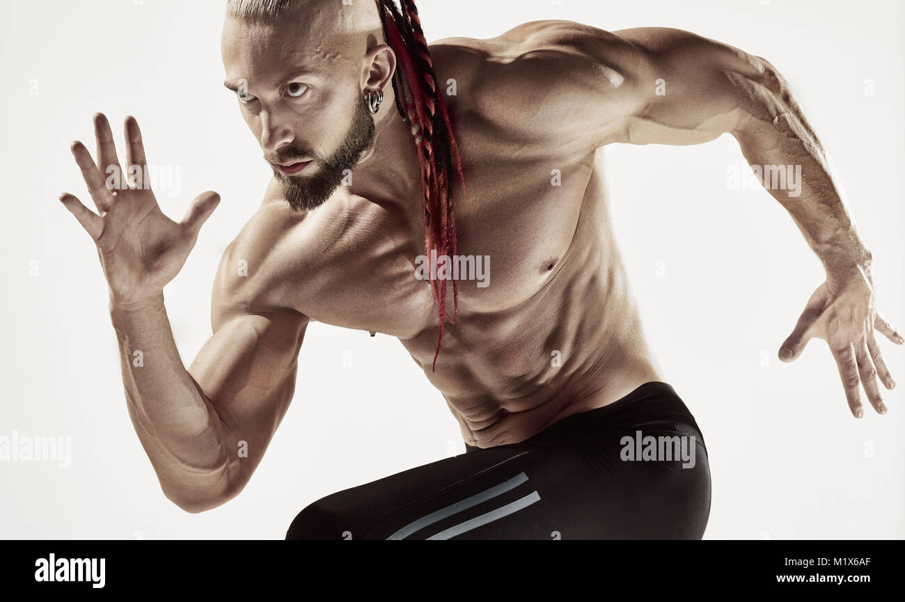 Fitness man running isolated on a gray Stock Photo - Alamy