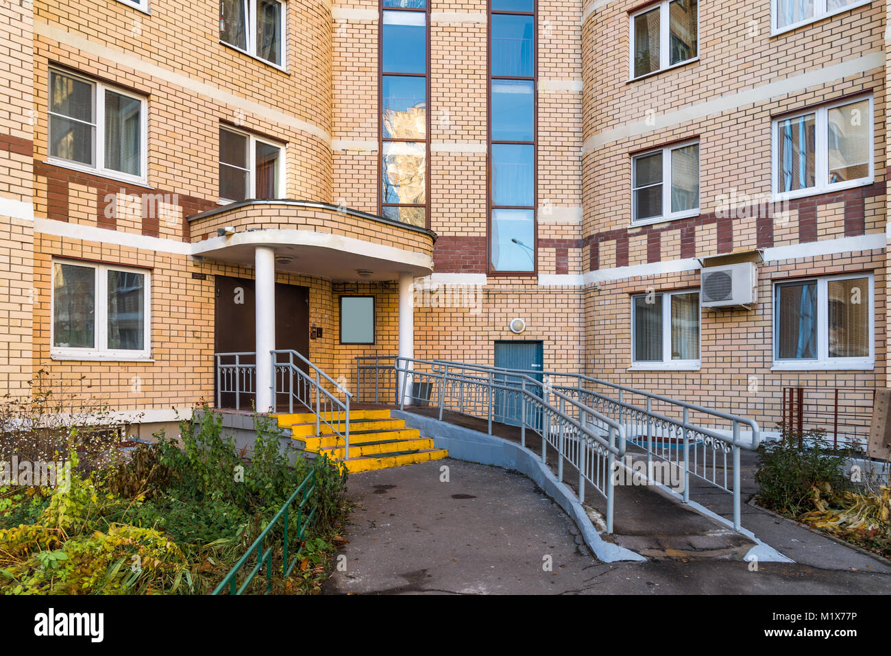 Entrance to a modern high-rise building made of bricks Stock Photo - Alamy