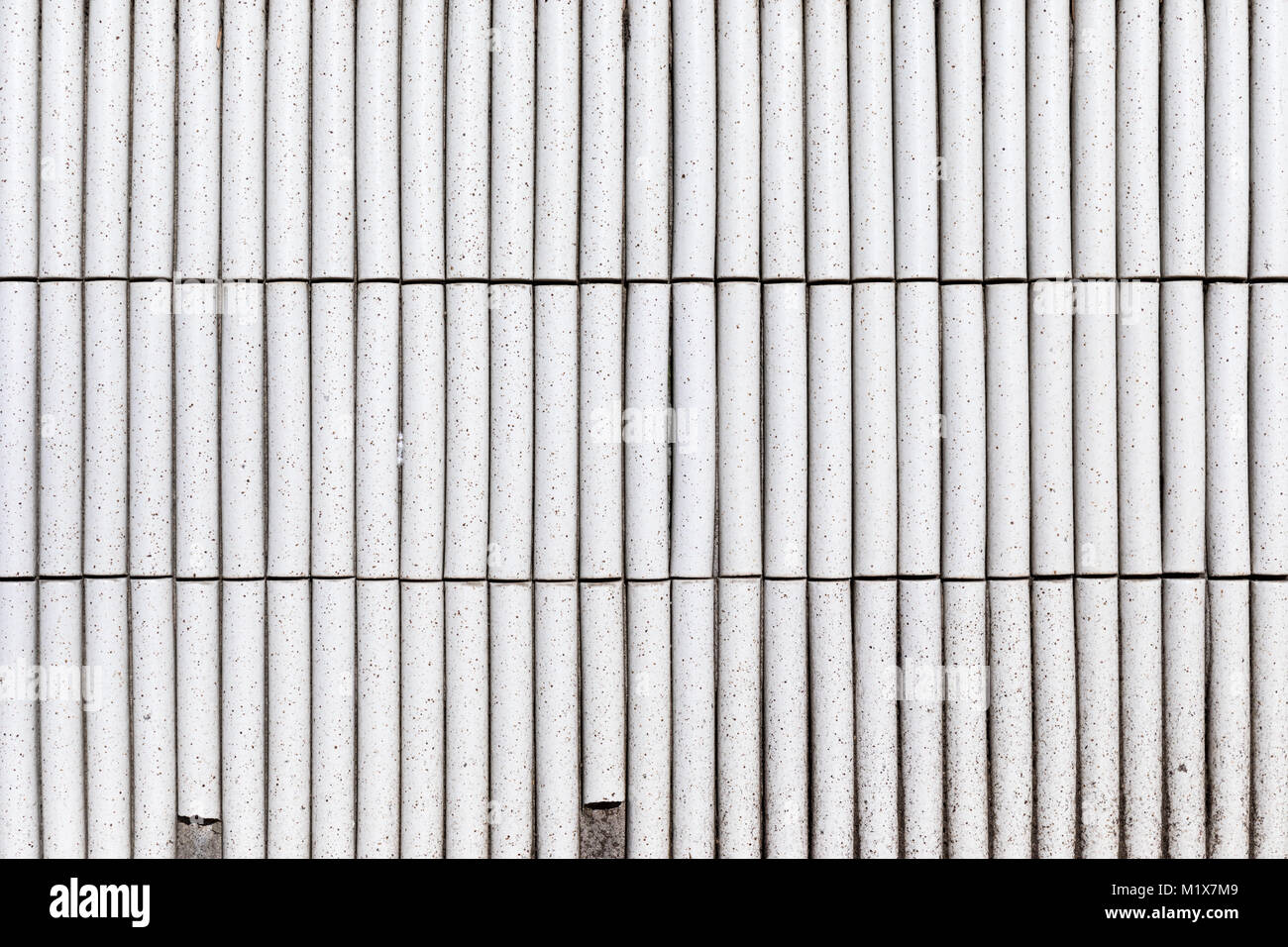 Wall with narrow white tiles Stock Photo - Alamy