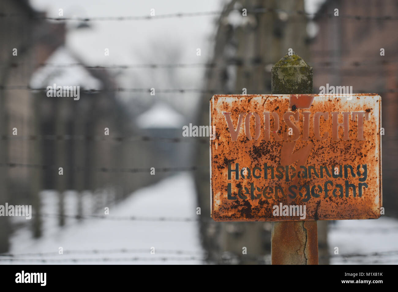 Vorsicht warning sign near barbed wire fences and barriers inside ...
