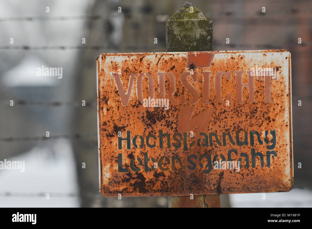 Vorsicht warning sign near barbed wire fences and barriers inside ...