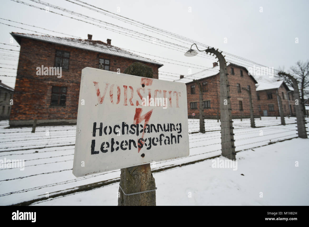 Vorsicht warning sign near barbed wire fences and barriers inside ...