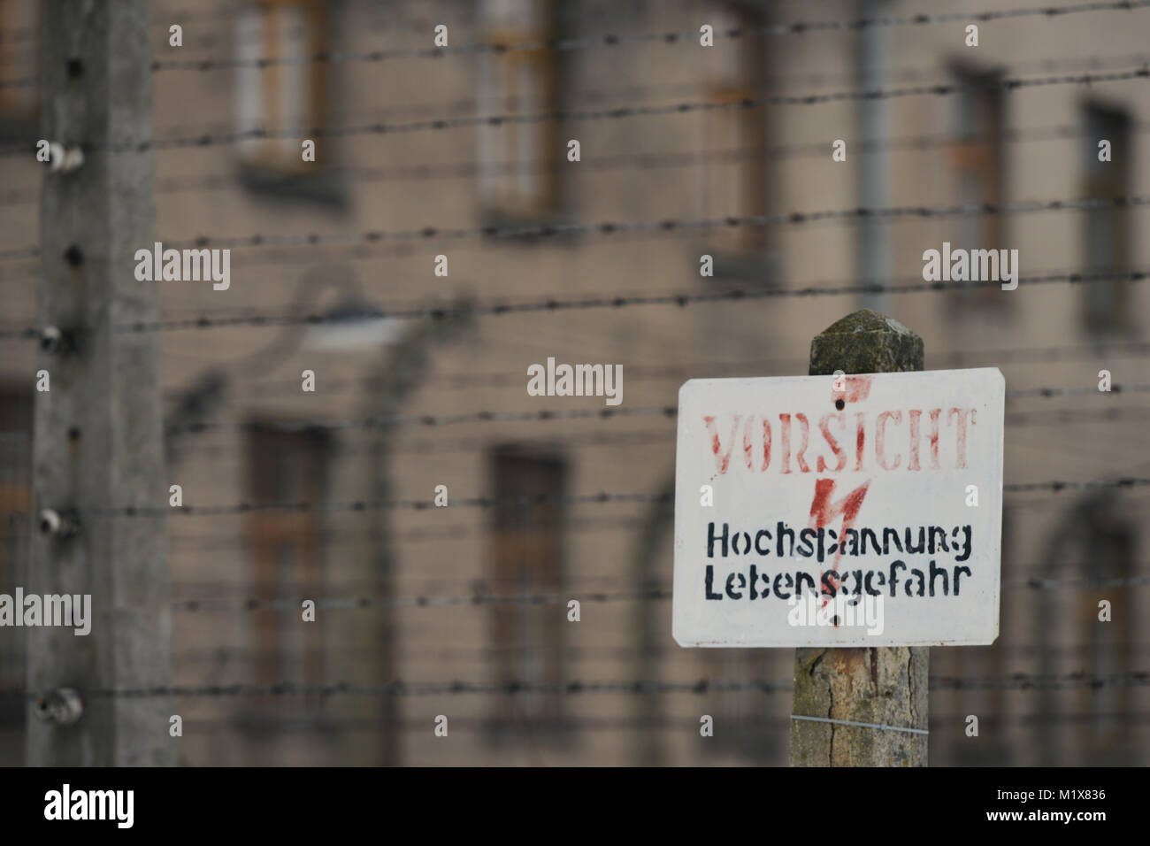 Vorsicht warning sign near barbed wire fences and barriers inside ...