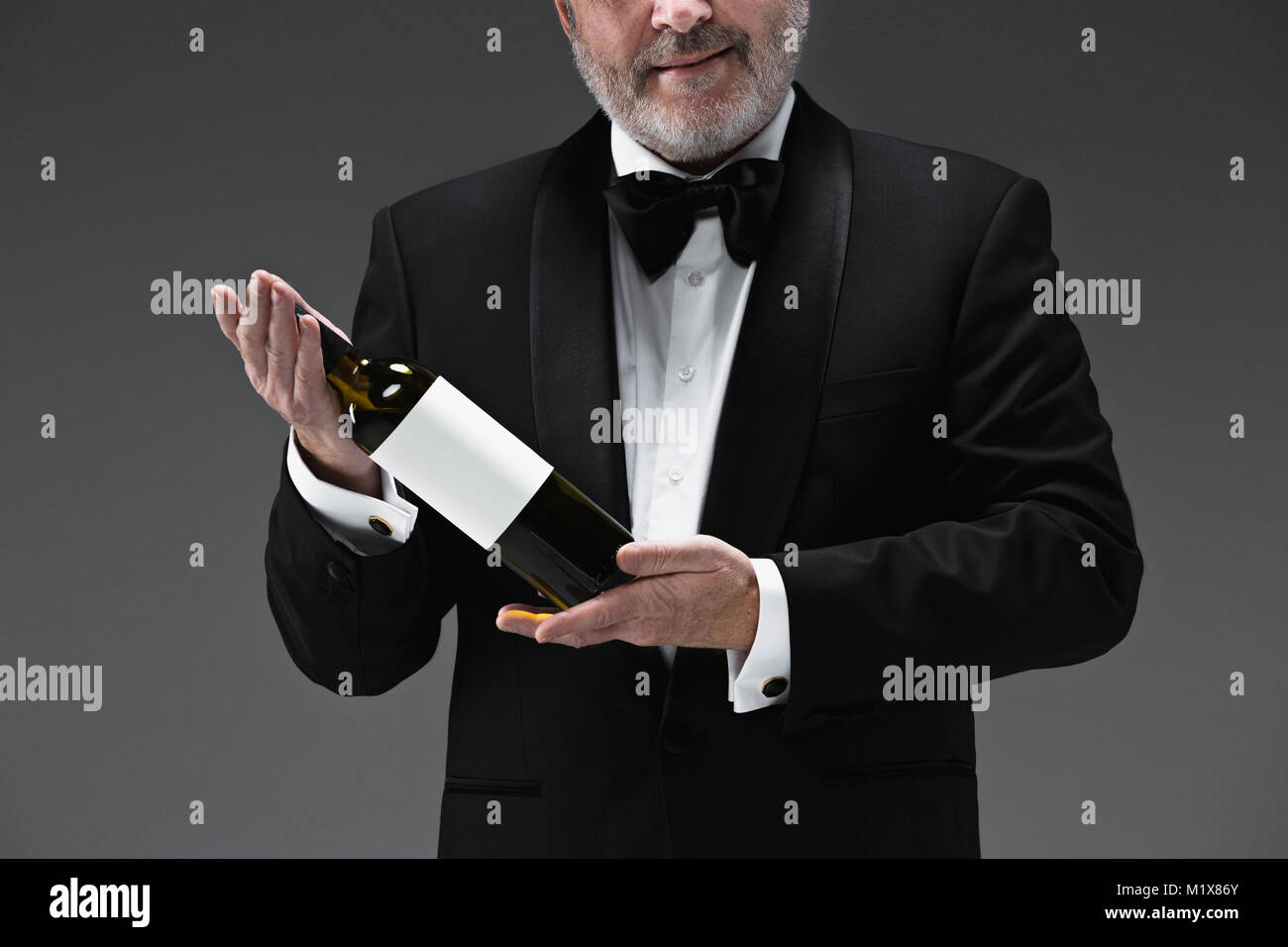 professional waiter in uniform is serving wine Stock Photo - Alamy