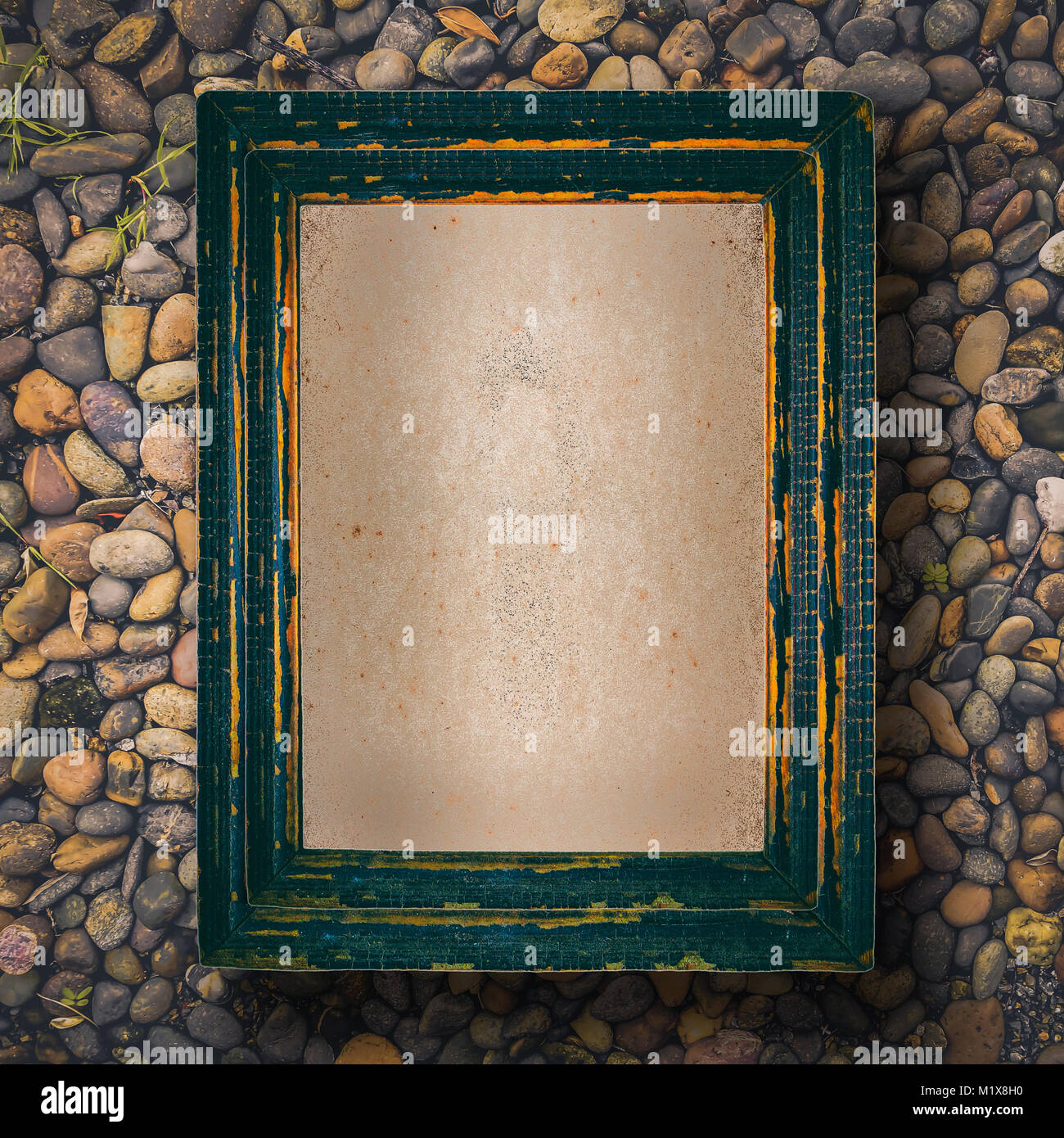 Top view of old picture frame with paper blank space put on stone on ...