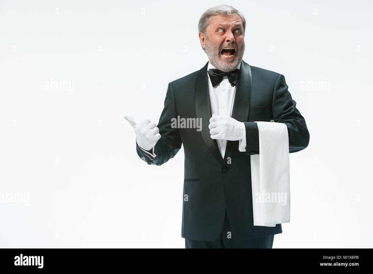 Senior waiter holding white towel Stock Photo - Alamy