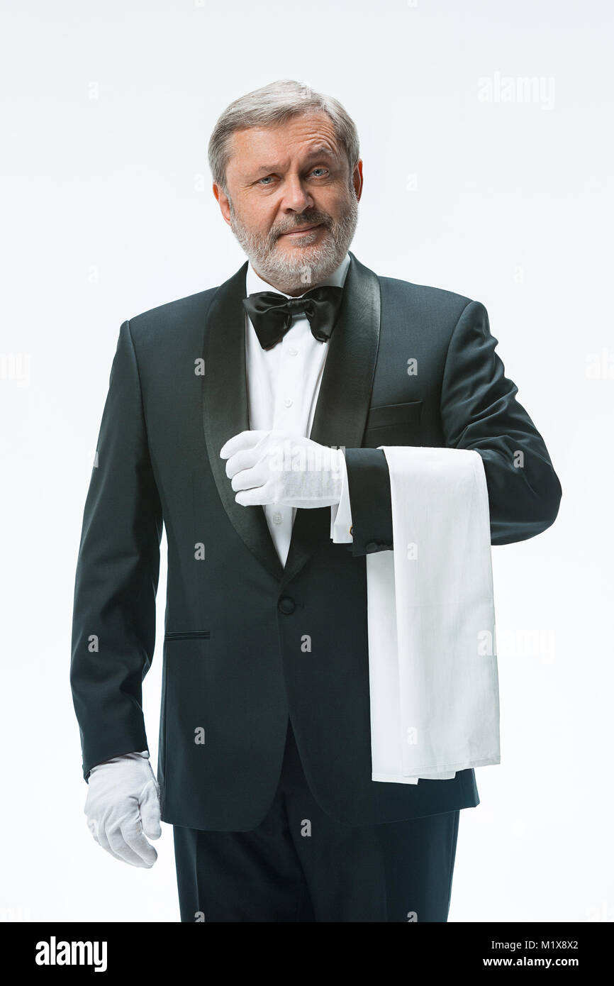 Senior waiter holding white towel Stock Photo - Alamy