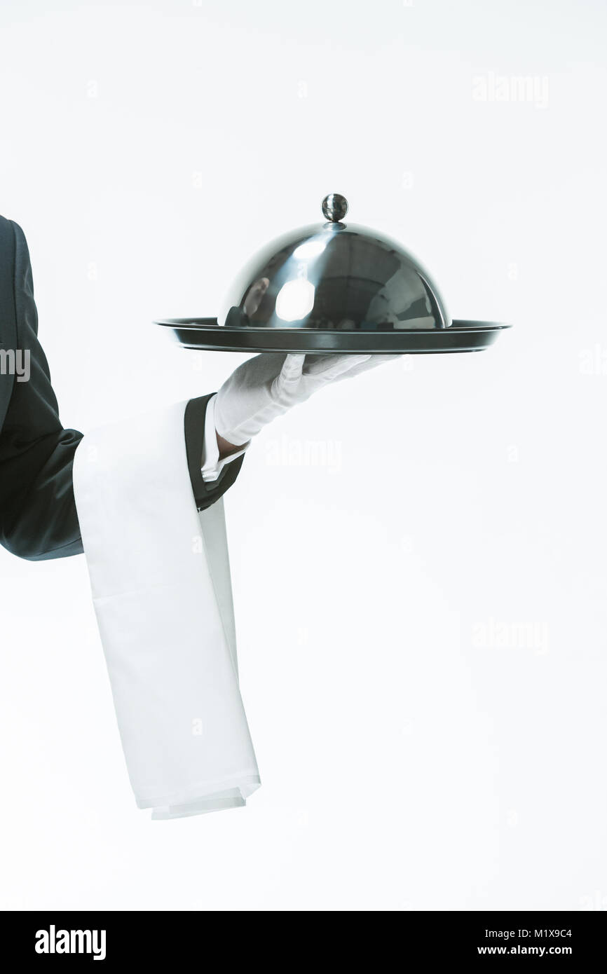 Close up waiter hand with tray and metal cloche lid cover Stock Photo ...
