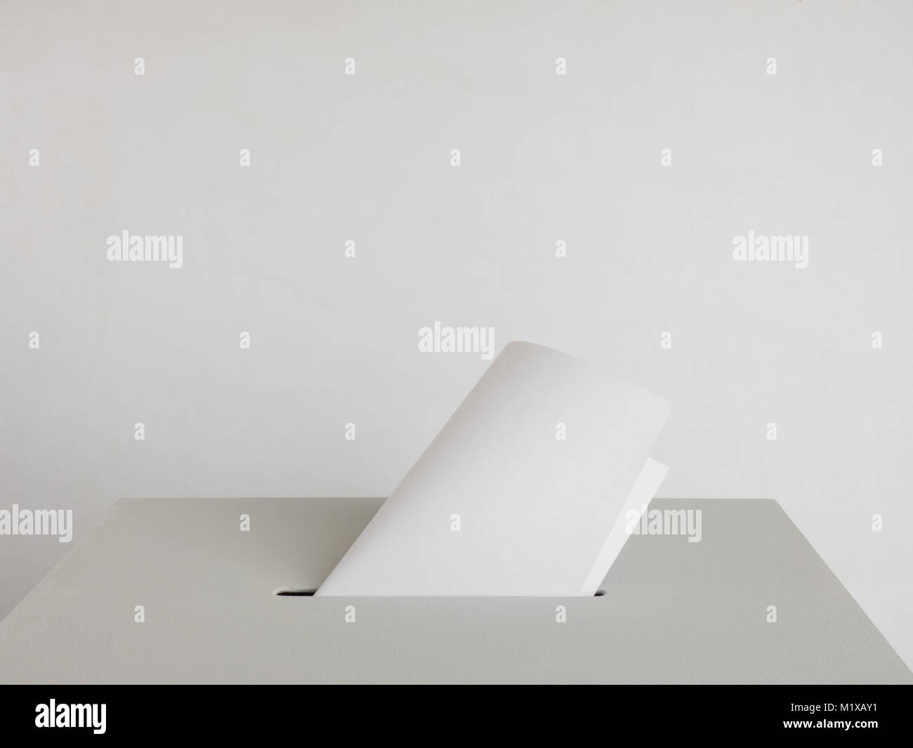 Ballot box with the ballot papers on gray background Stock Photo - Alamy