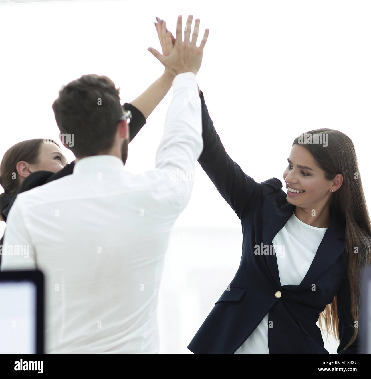 closeup.business team, giving each other a high five Stock Photo - Alamy