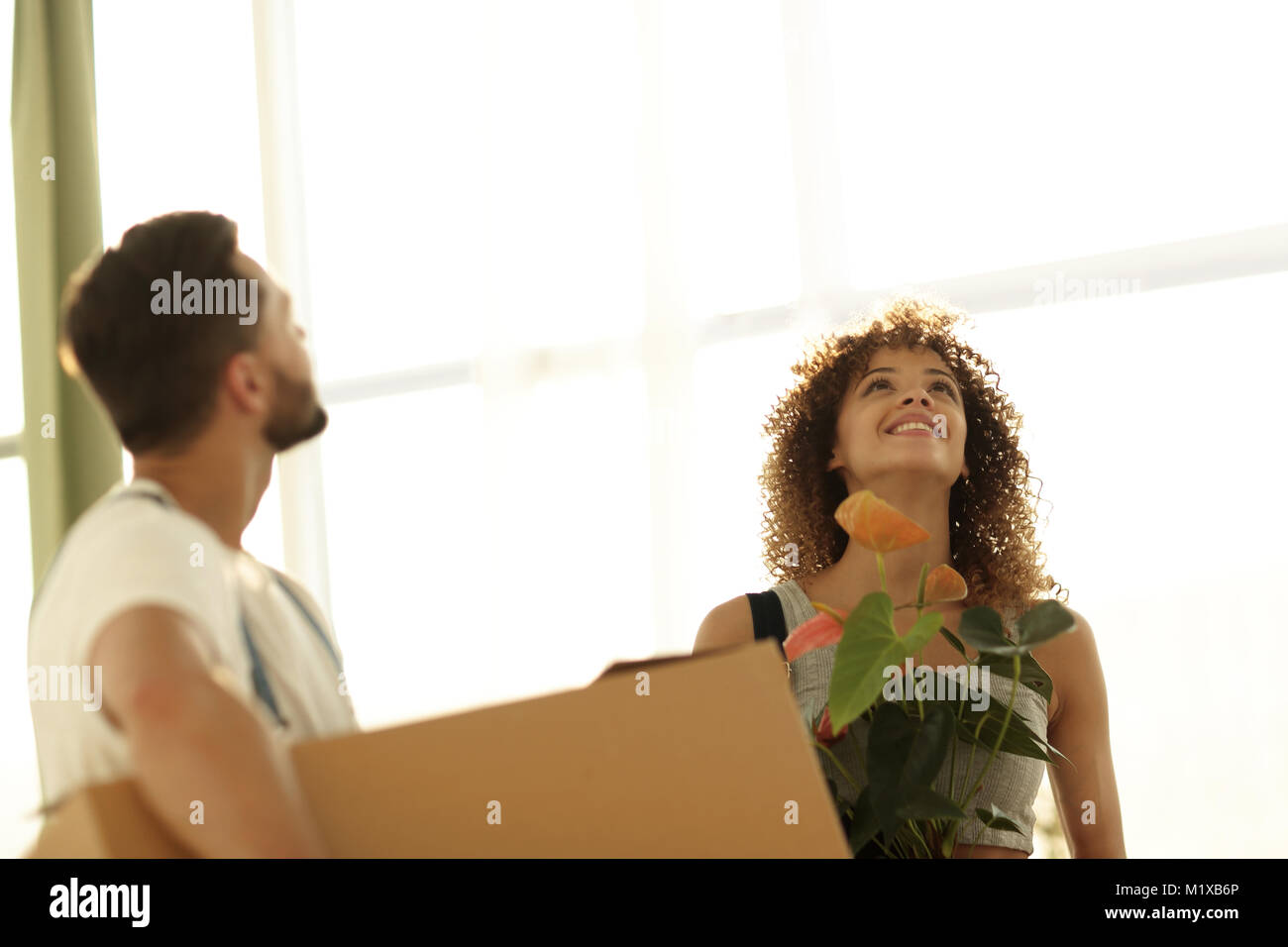 Husband and wife bring boxes with things to a new apartment Stock Photo ...