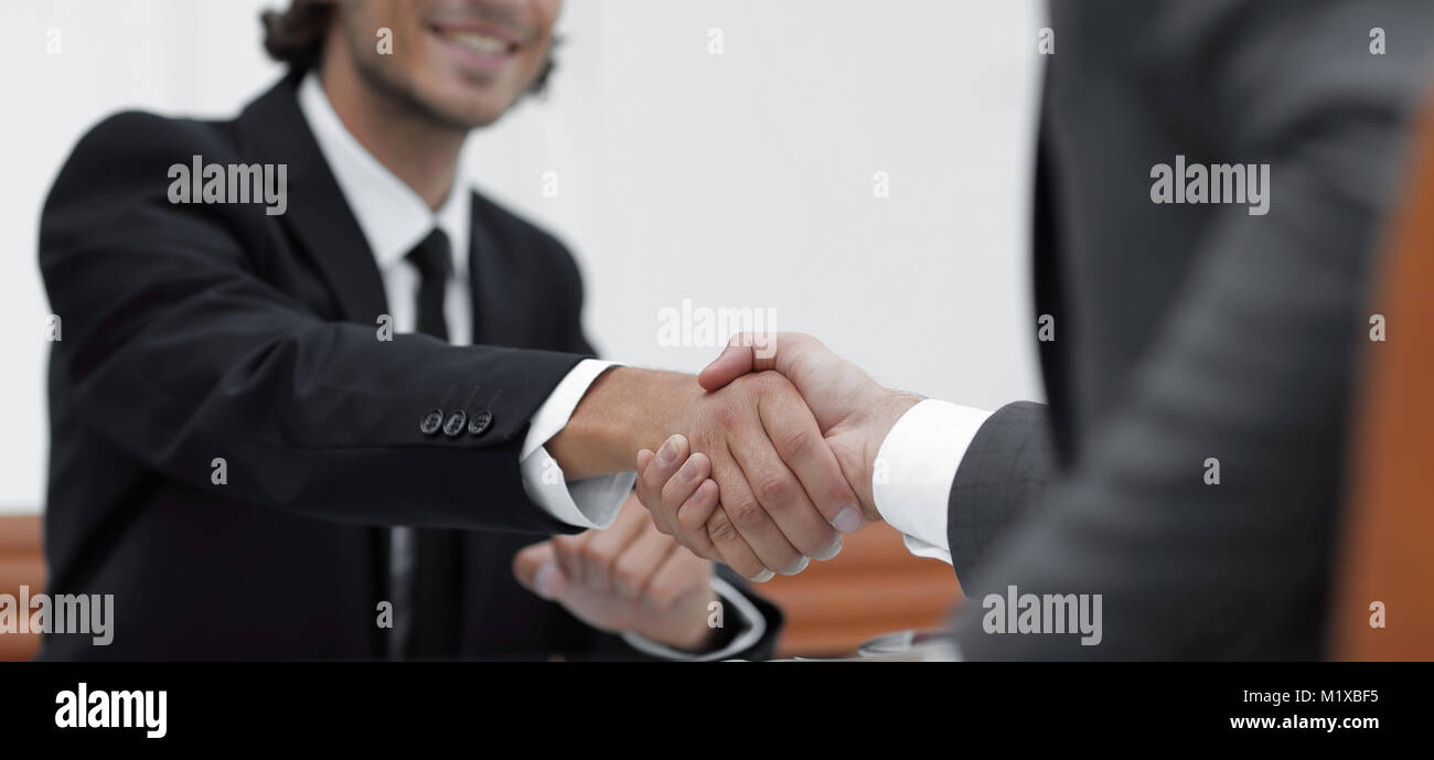handshake Manager and the client sitting in the office Stock Photo - Alamy