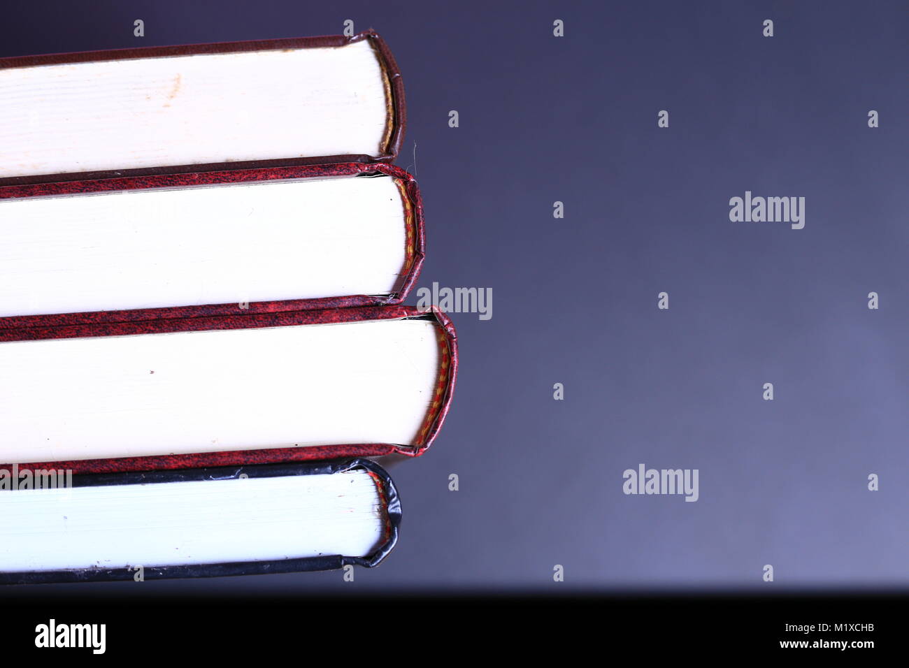 Stack of old books isolated on black background Stock Photo - Alamy