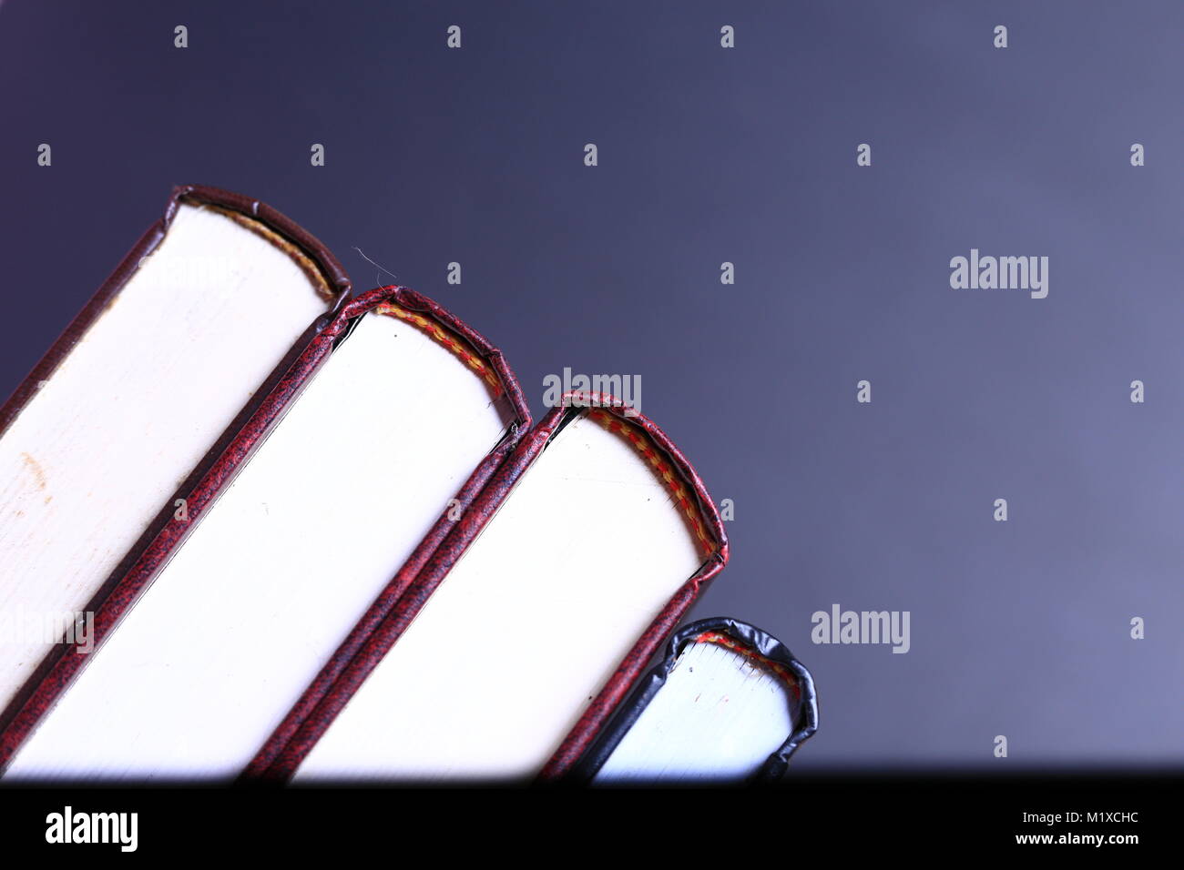 Stack of old books isolated on black background Stock Photo - Alamy