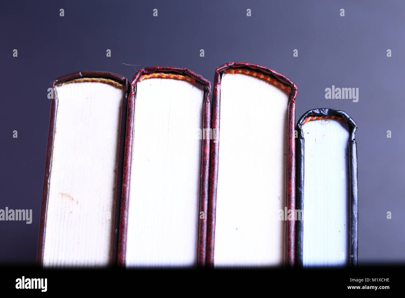 Stack of old books isolated on black background Stock Photo - Alamy