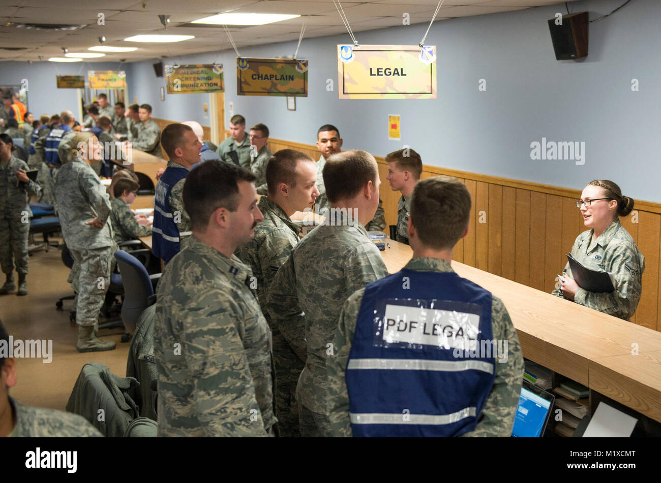 Service members process the deployment line during a base exercise at ...