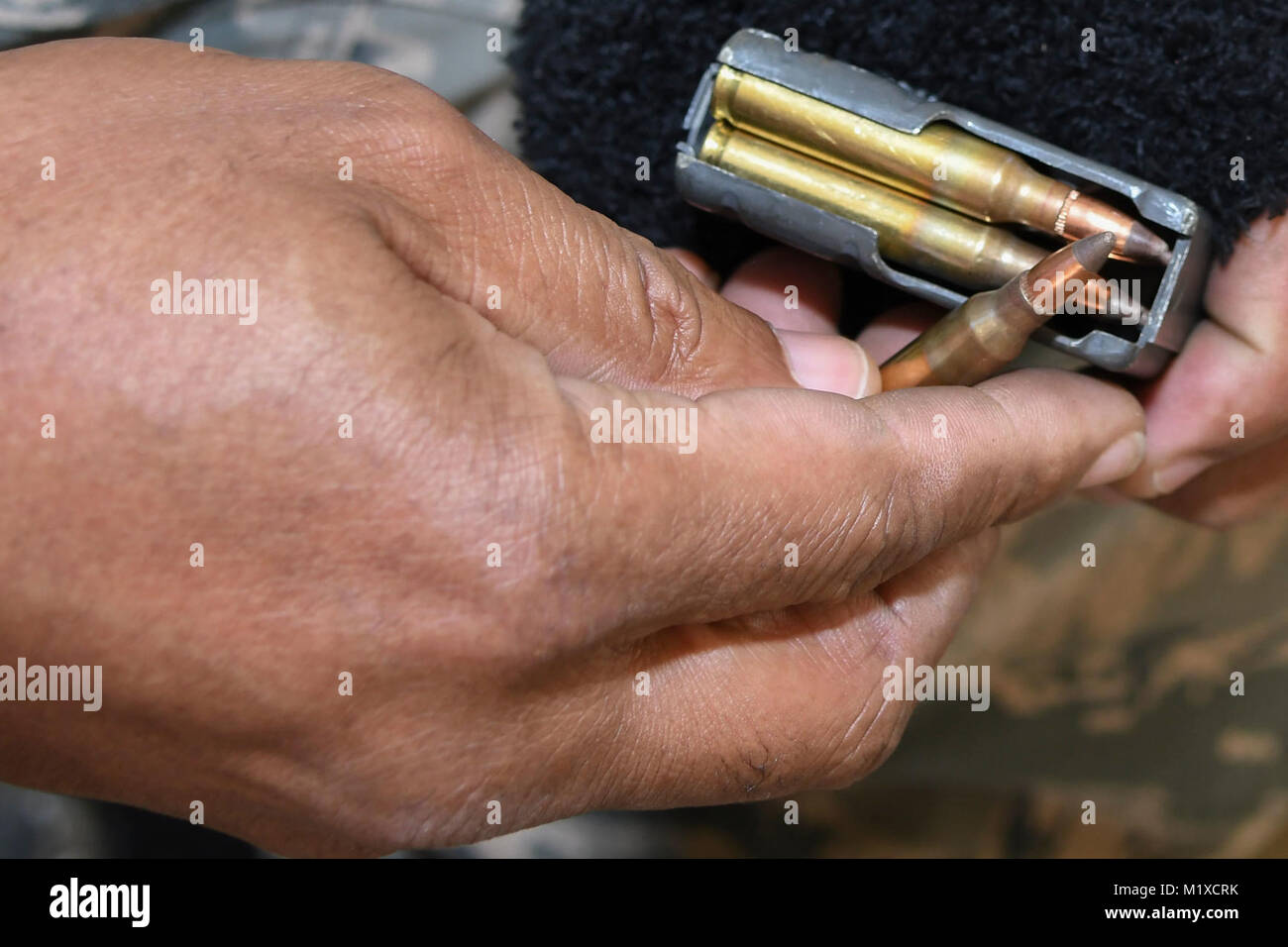 An Airman from the 307th Logistics Readiness Squadron loads an M4 ...