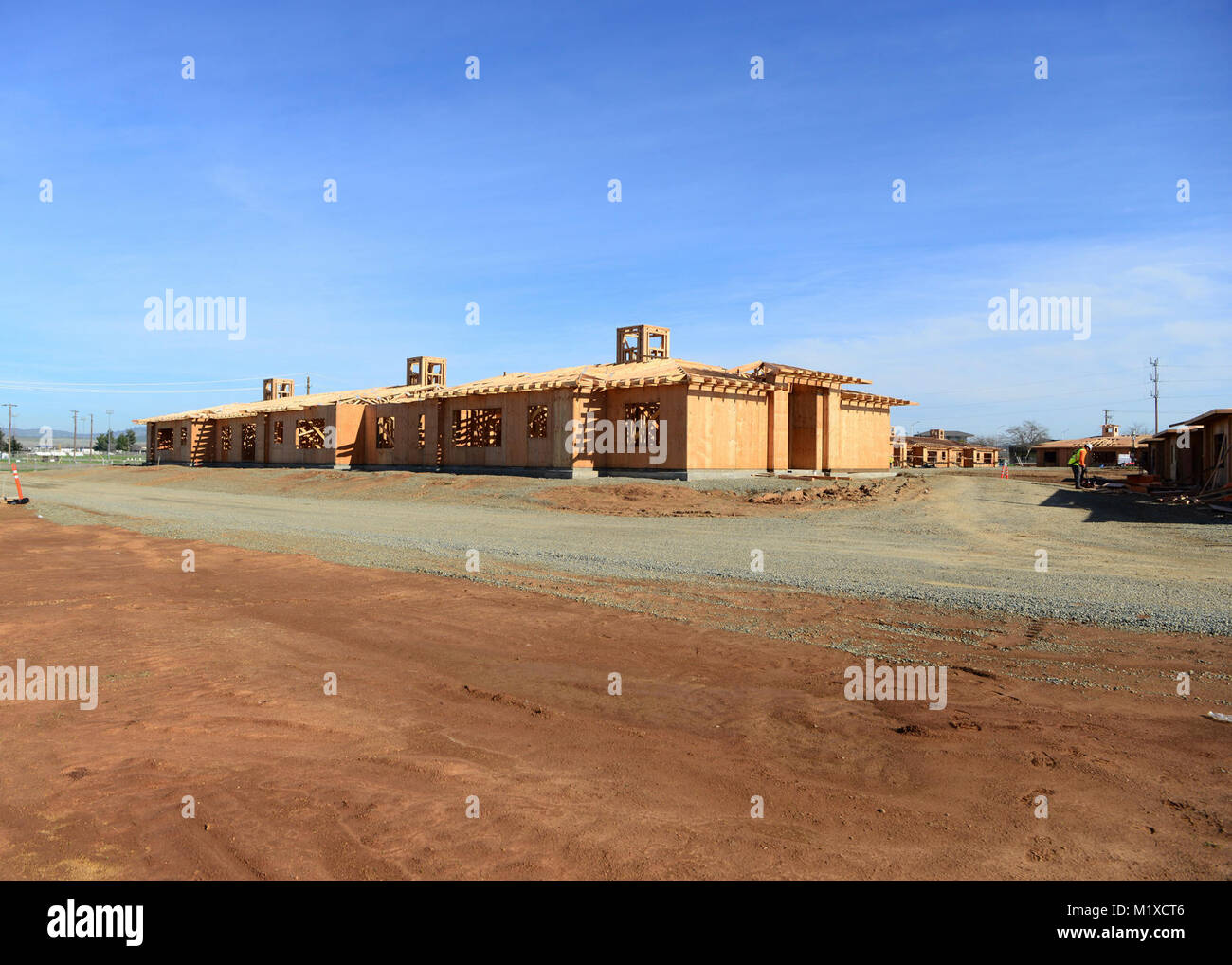 Construction workers build a new temporary living facility on Beale Air ...