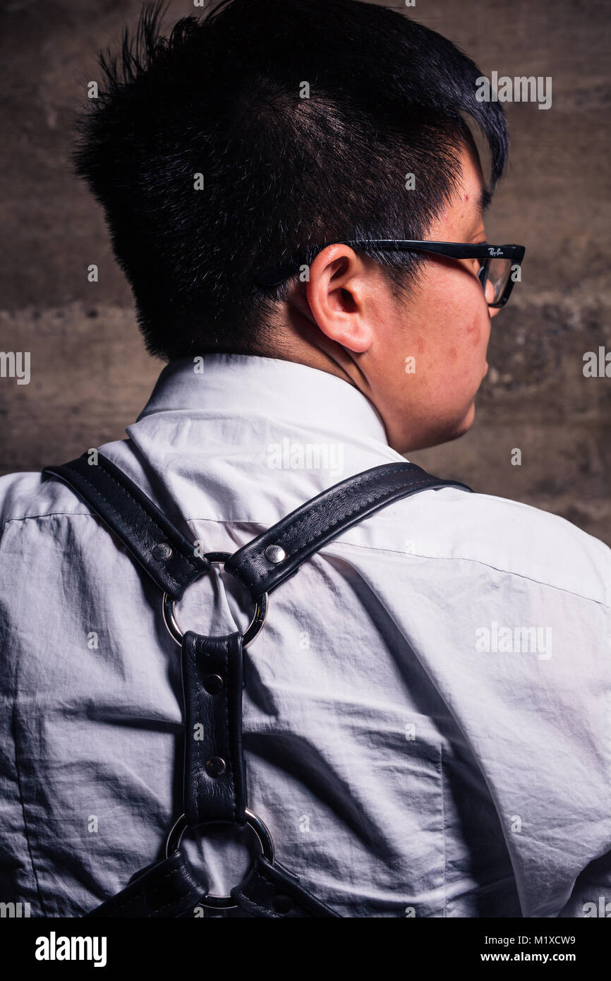 Young transgender man in semi formal clothing with a bondage style ...