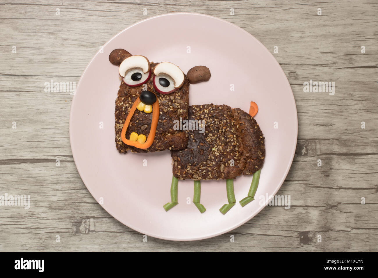 Funny sandwich in form of barking dog on plate and wood Stock Photo - Alamy