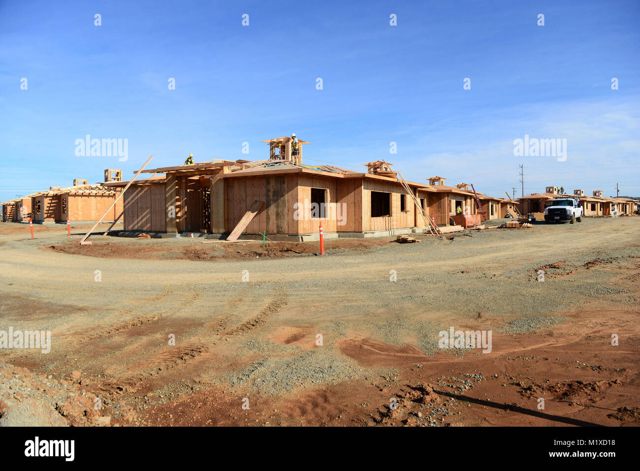 Construction workers build a new temporary living facility on Beale Air ...