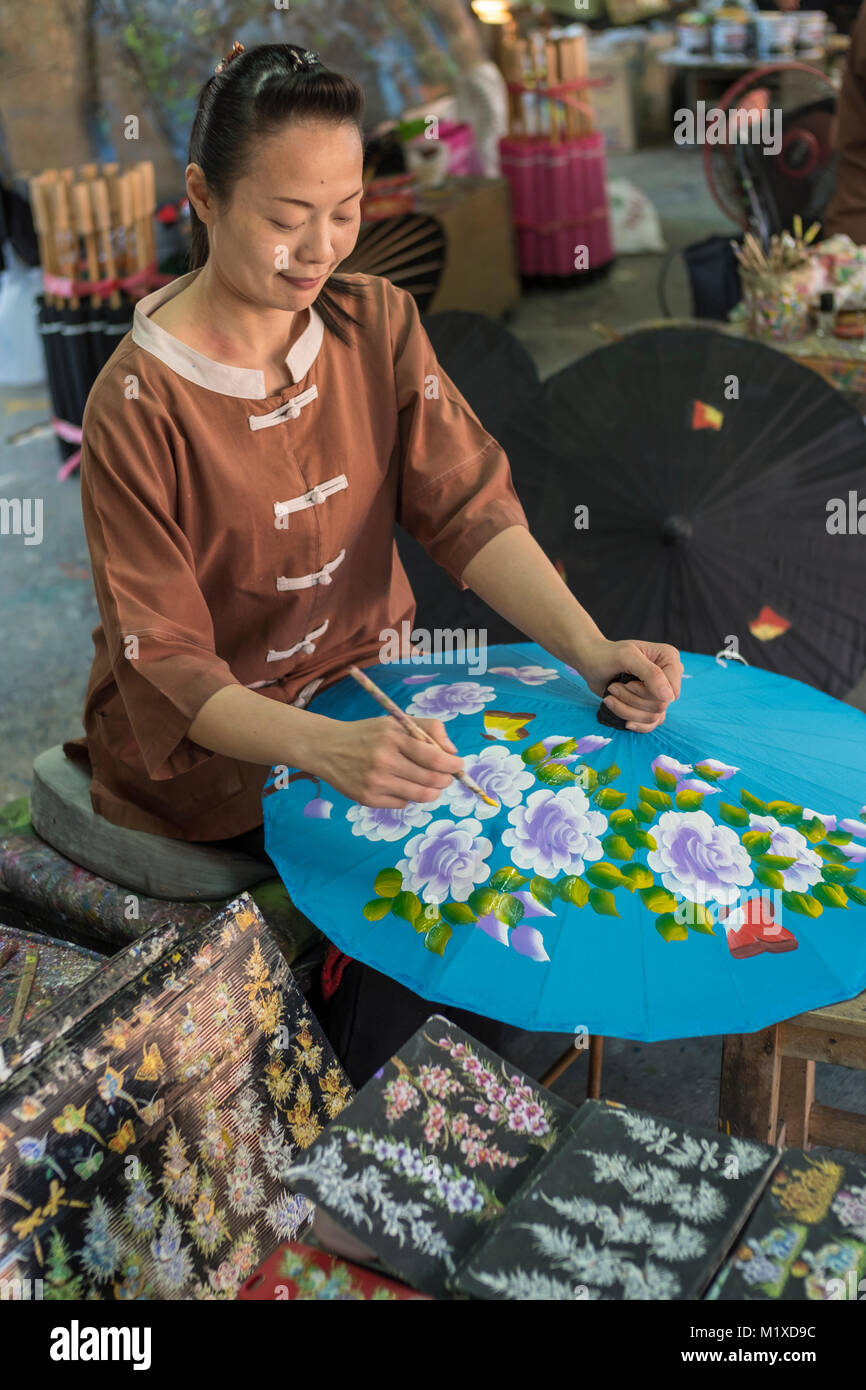 A Thai craftswoman making traditional umbrella at Umbrella Making ...