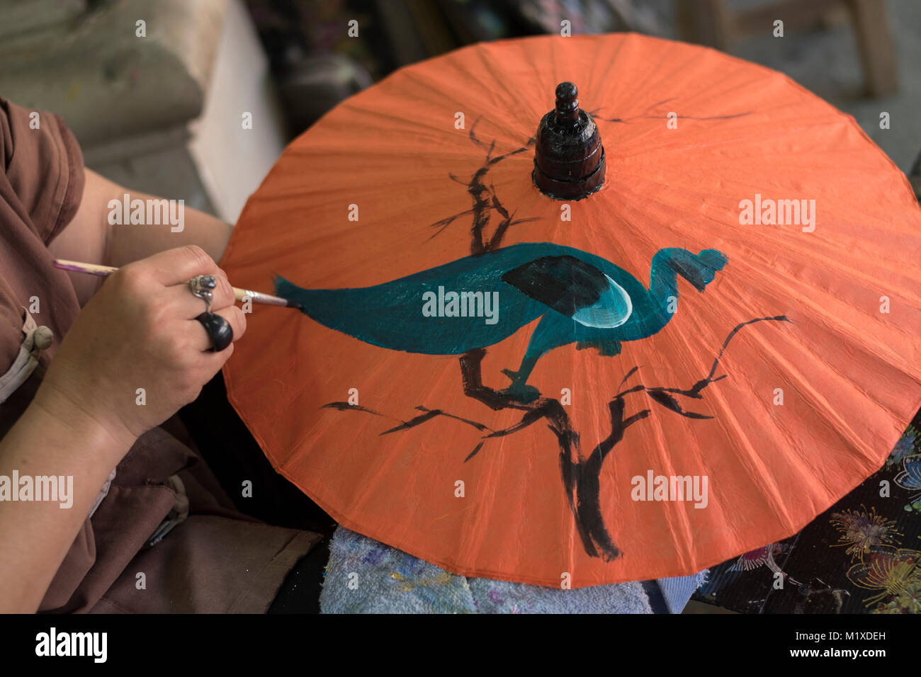 A Thai craftswoman making traditional umbrella at Umbrella Making ...