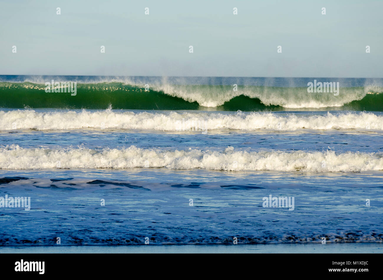 Breaking waves and windblown spray, Porangahau, New Zealand Stock Photo ...