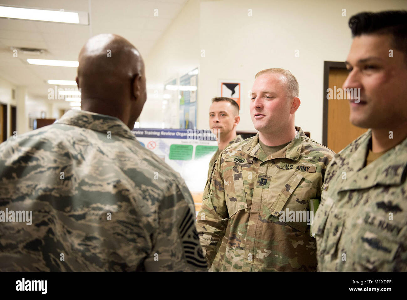 Army Capt. Christopher Gibbs, center, greets Chief Master Sgt. of the ...